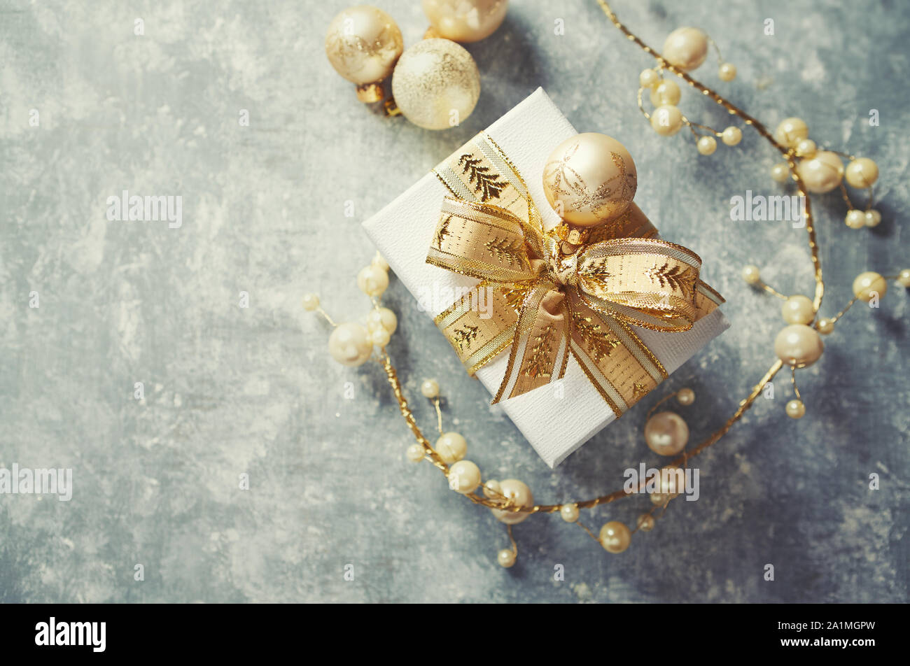 Christmas Present with Gold Ribbon and Gold Christmas Decorations ...