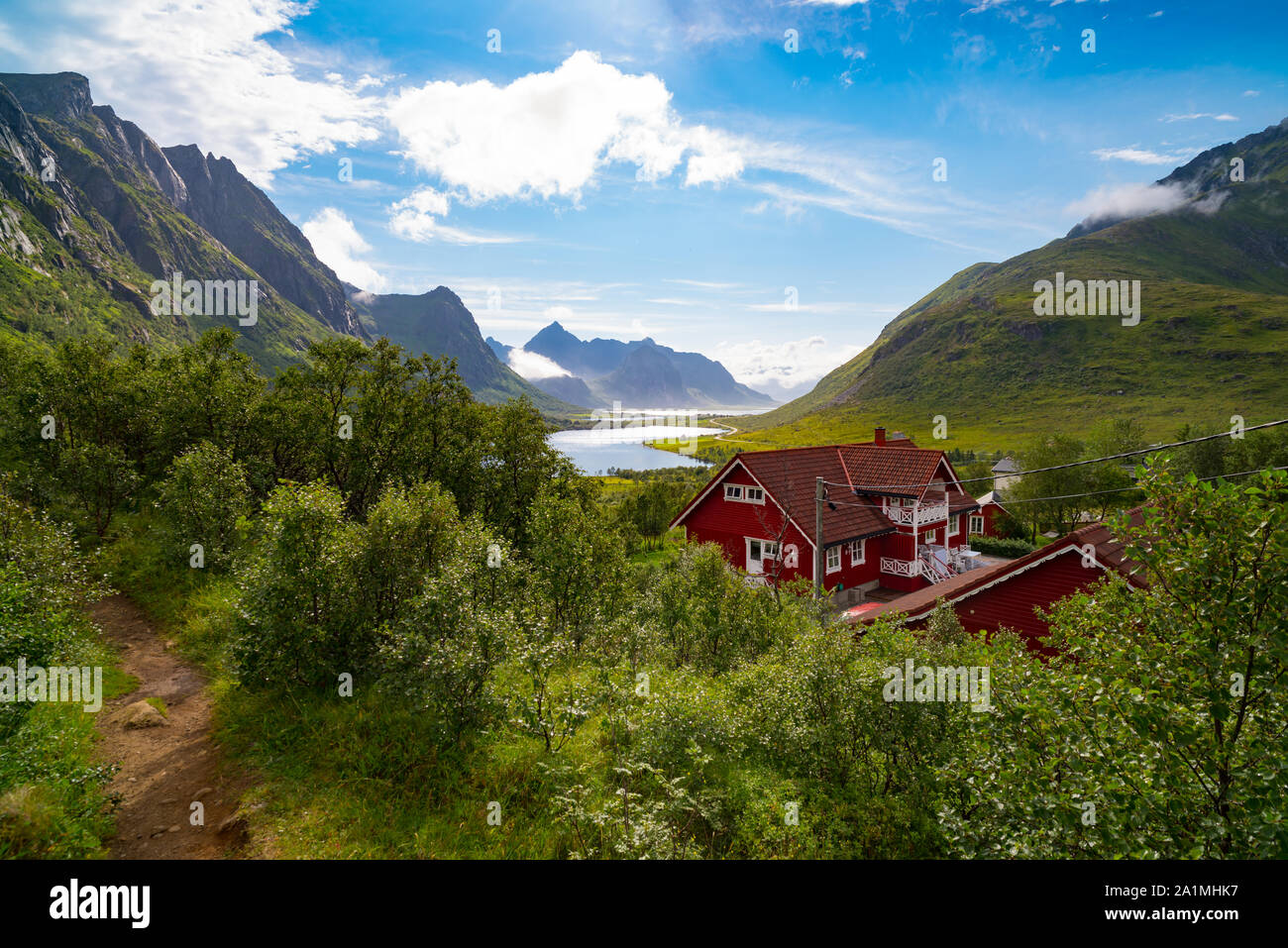 typical norwegian red house surrounded by the beautiful nature of the ...