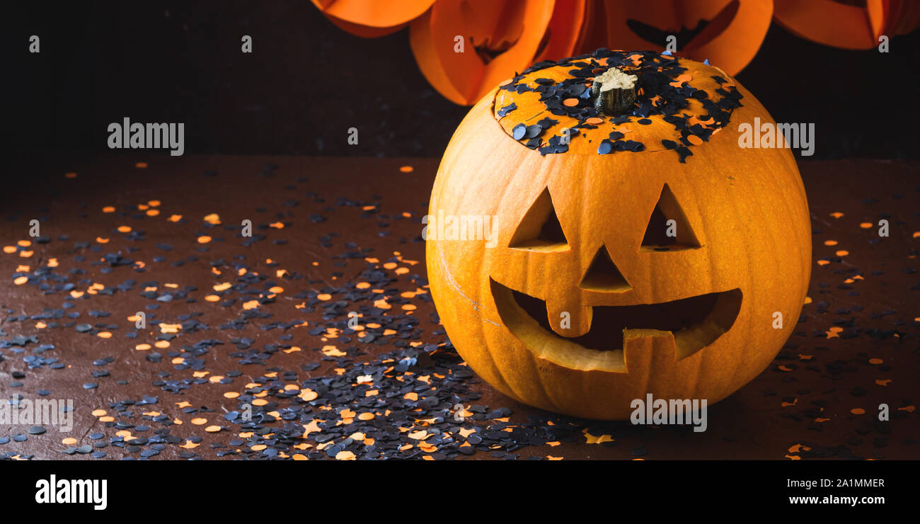 Halloween carved squash and confetti. Dark Holiday spooky background ...