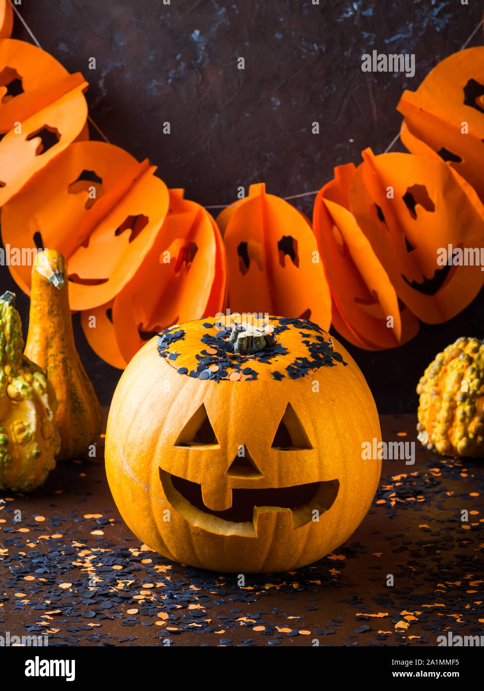 Halloween carved squash and confetti. Dark Holiday spooky background ...