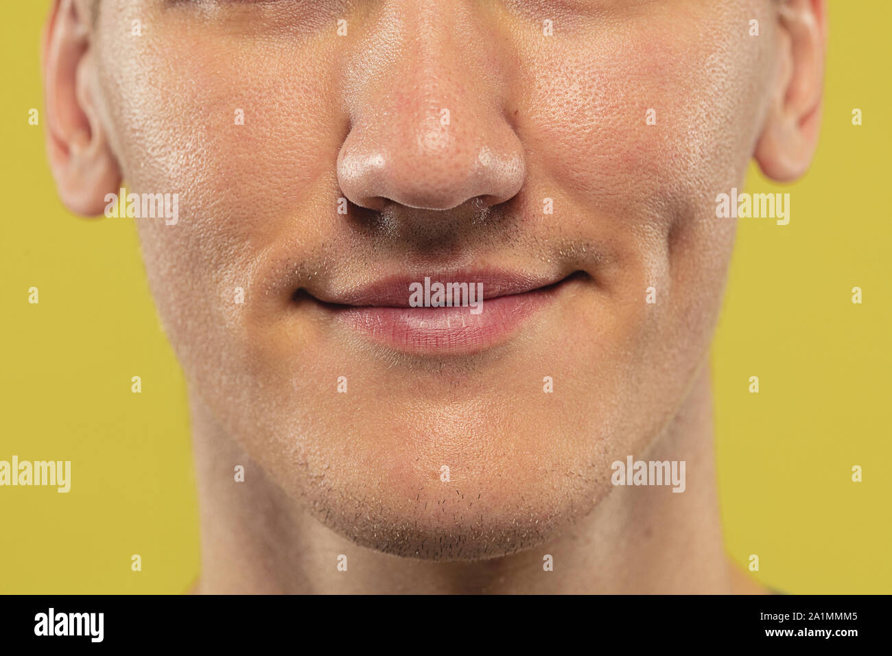 Caucasian young man's close up on yellow studio background. Beautiful ...