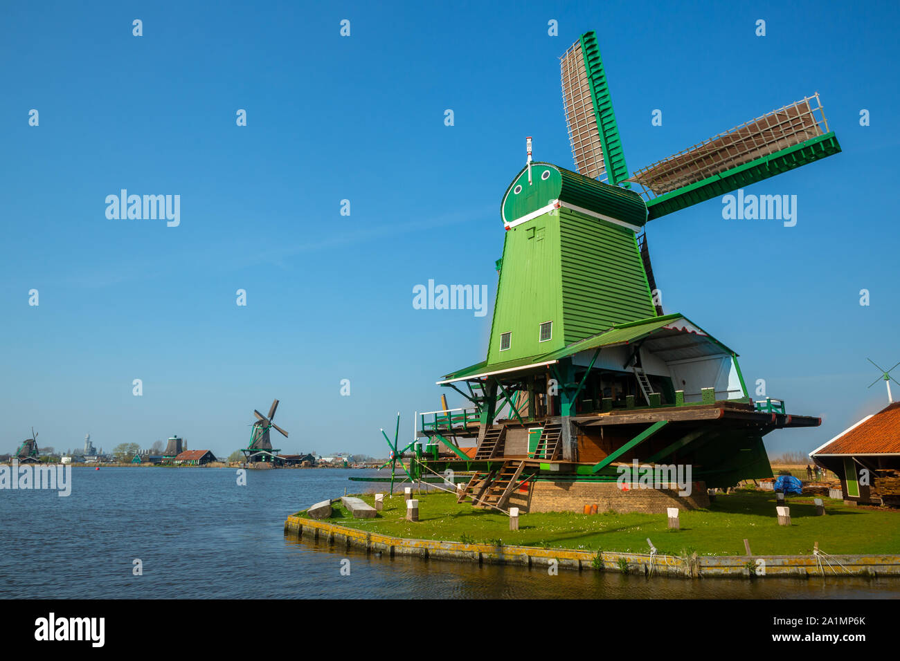 old time classic windmill on the bank of a lake landscape photo Stock ...