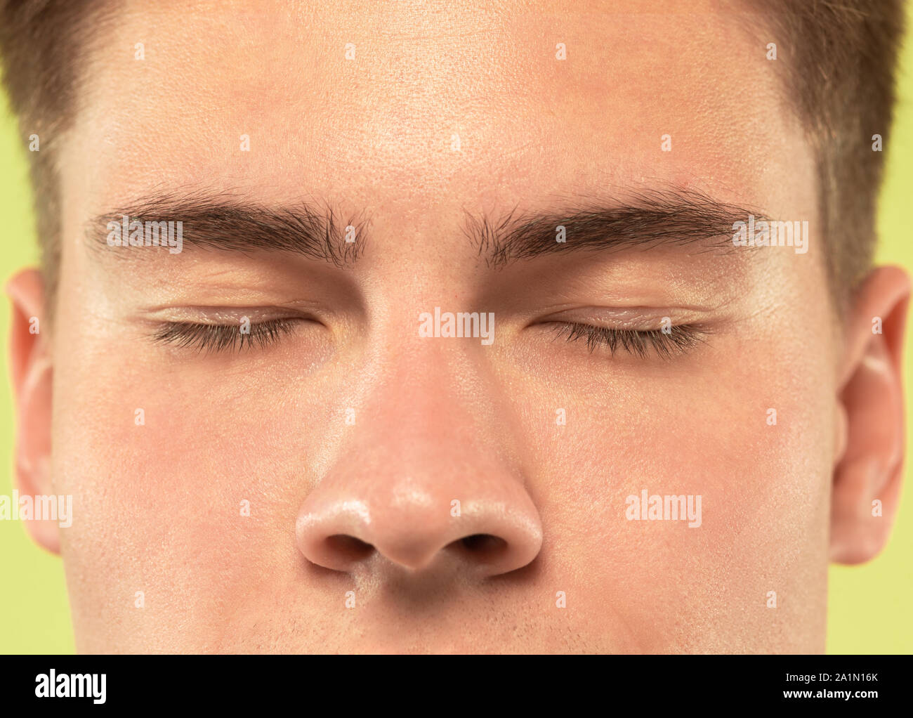 Caucasian young man's close up shot on studio background. Beautiful ...
