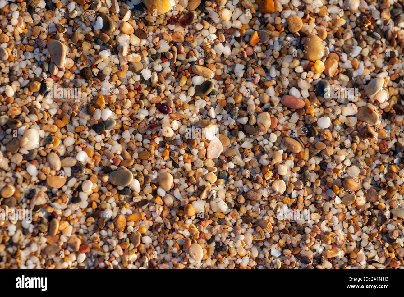 sea pebbles colored granite on the beach background stones. The shore ...