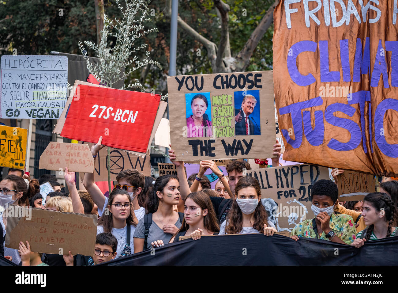 Protesters hold placards against climate change during the ...