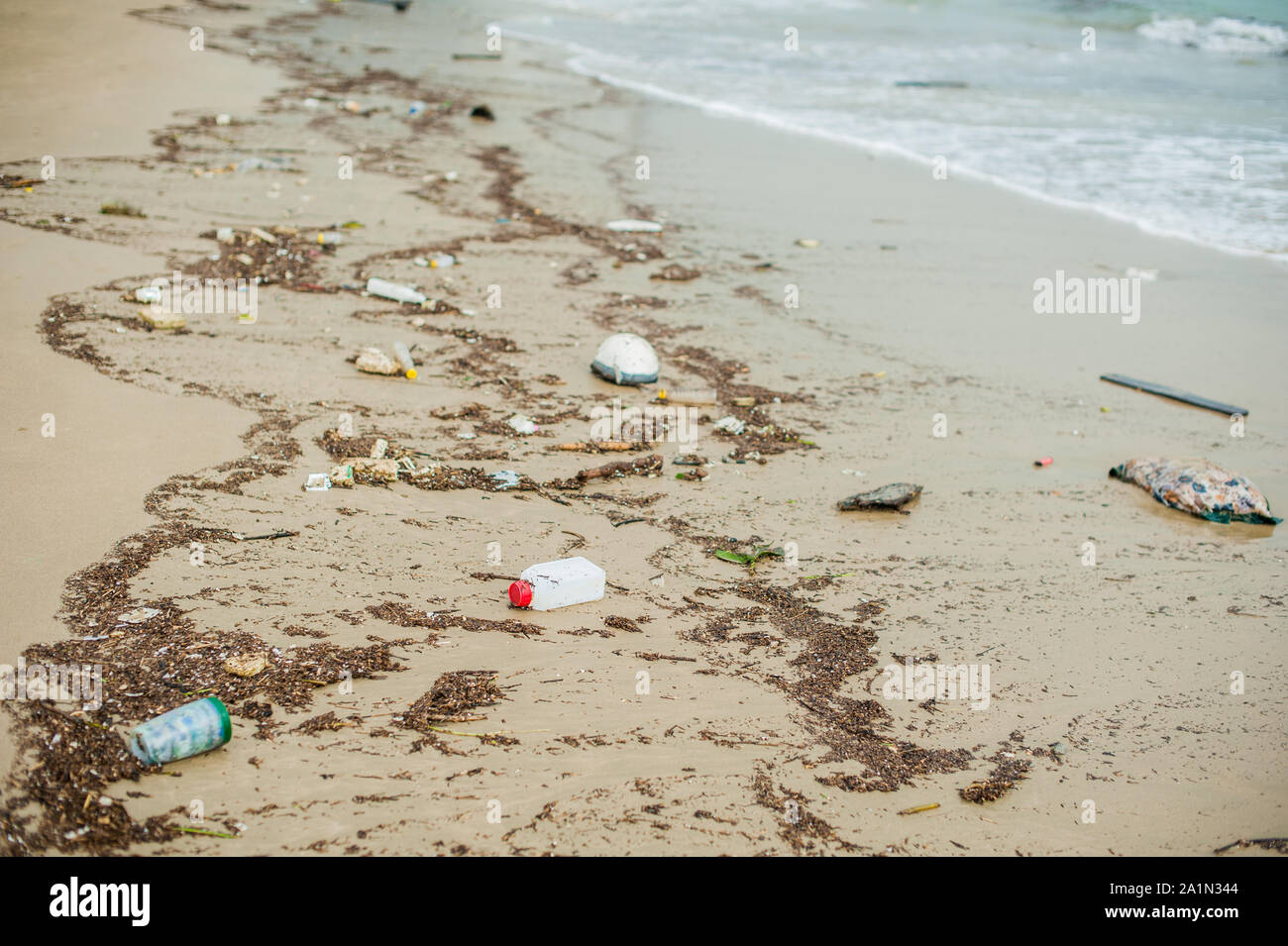 Beach pollution. Plastic bottles and other trash on sea beach Stock ...