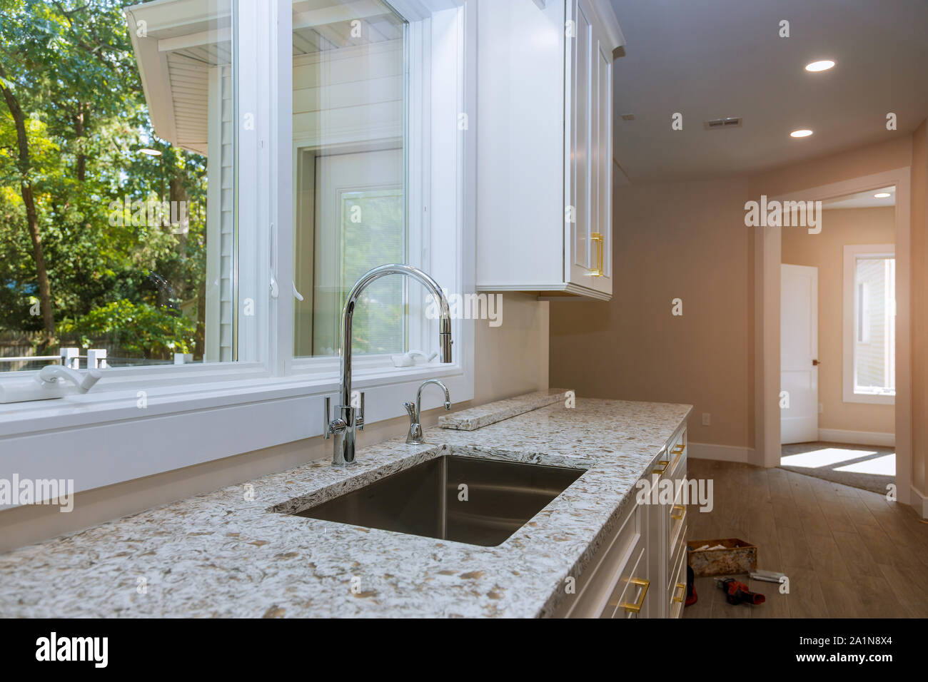 New modern white kitchen with built in chrome water tap Stock Photo - Alamy