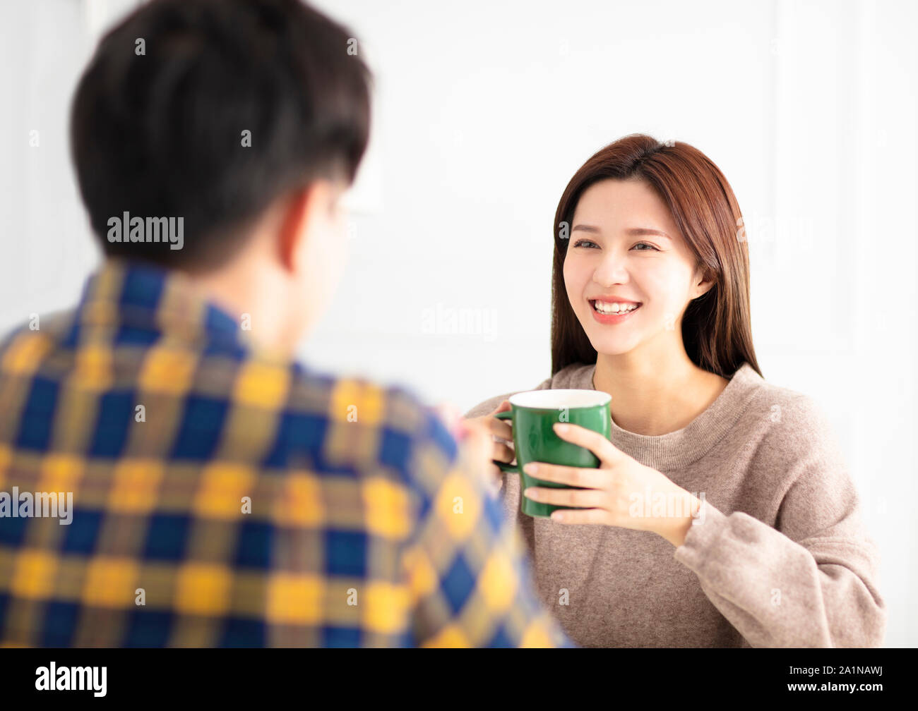 Young couple sitting face face hi-res stock photography and images - Alamy