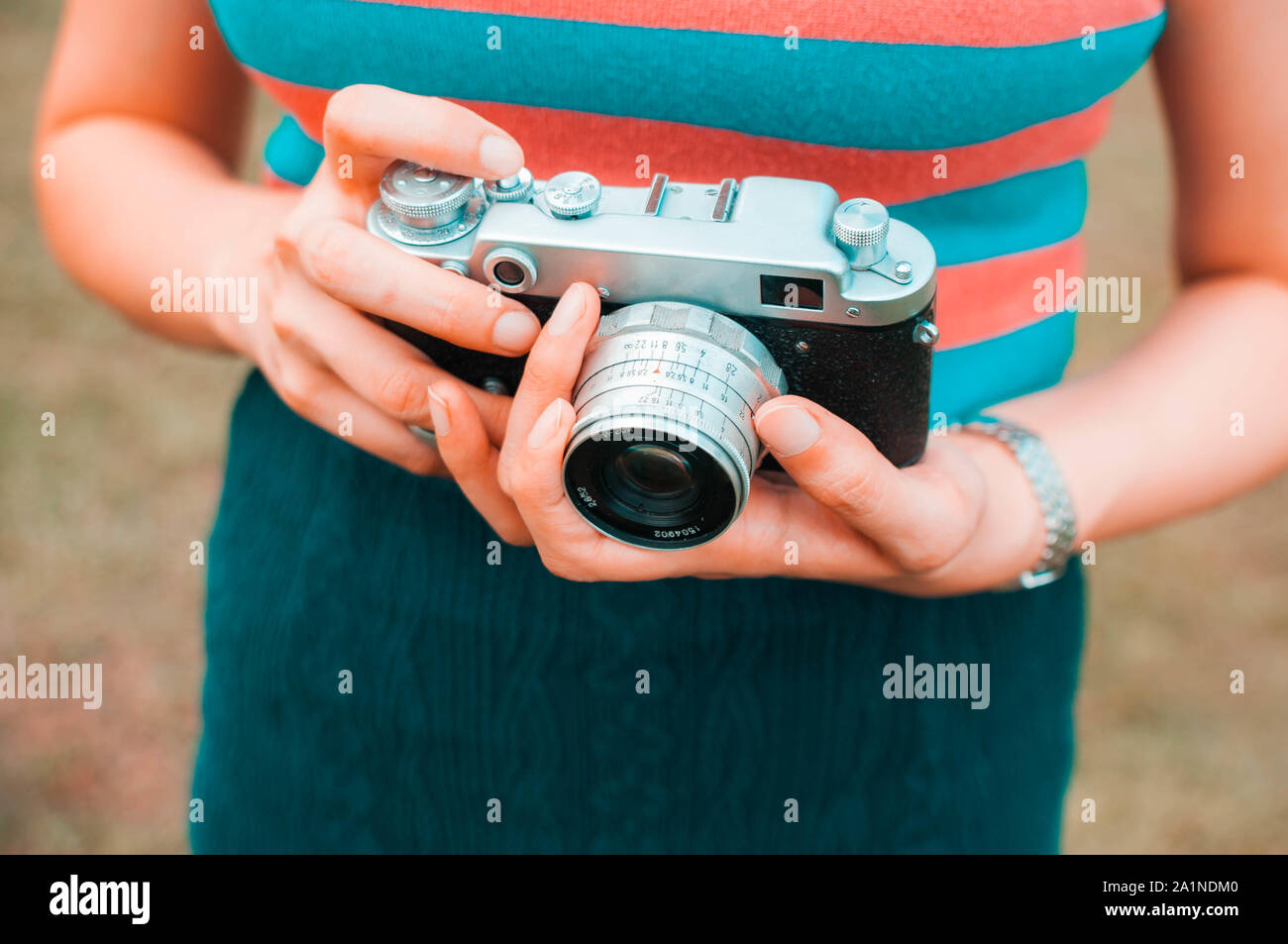 A young woman is carrying a vintage camera outdoor Stock Photo - Alamy