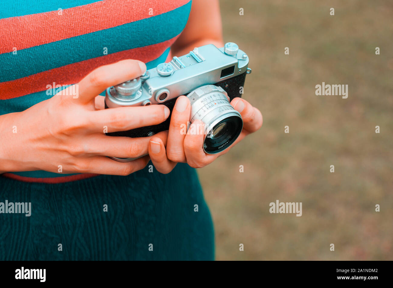 A young woman is carrying a vintage camera outdoor Stock Photo - Alamy