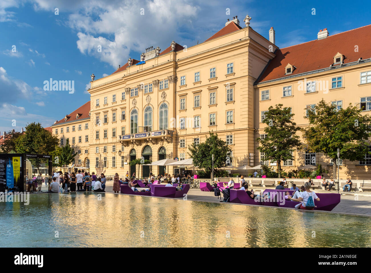 Tourists resting on seating in the Museum Quarter, Vienna, Austria ...