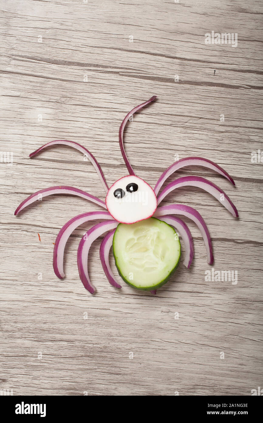 Funny spider made with fresh vegetables on board Stock Photo - Alamy