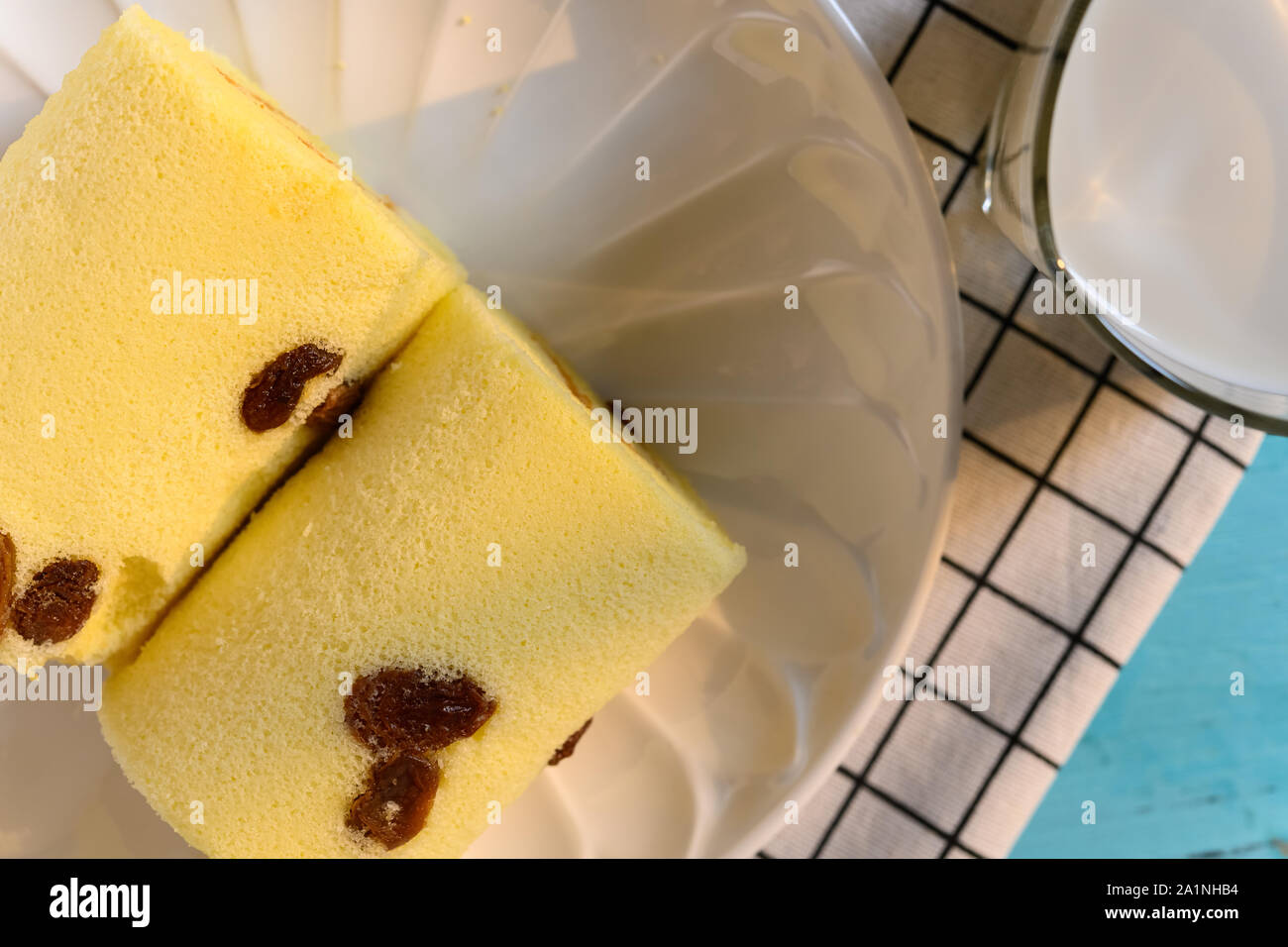 top view cakes with raisin and cup of milk close up in a sunny morning ...