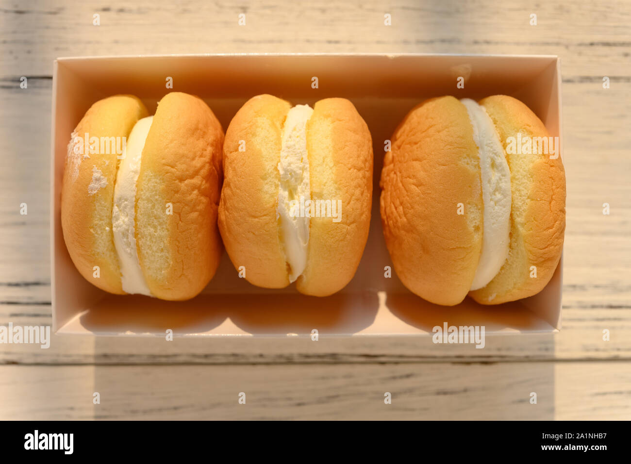 top view box of cakes with cream filling in a sunny morning Stock Photo ...