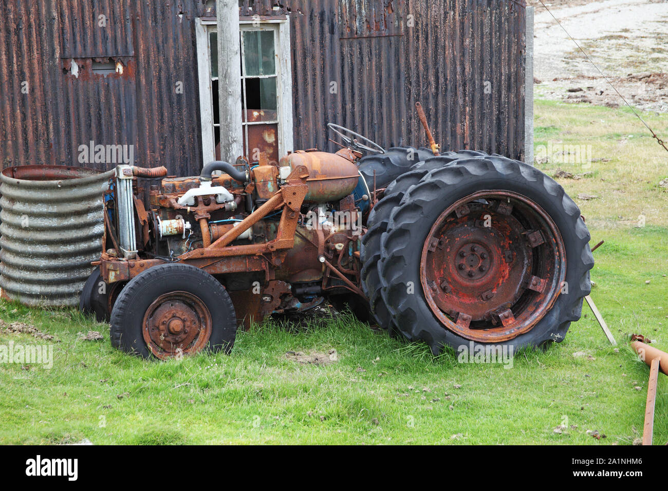 Ancient tractor by building in the settlement Pebble Island Falkland ...