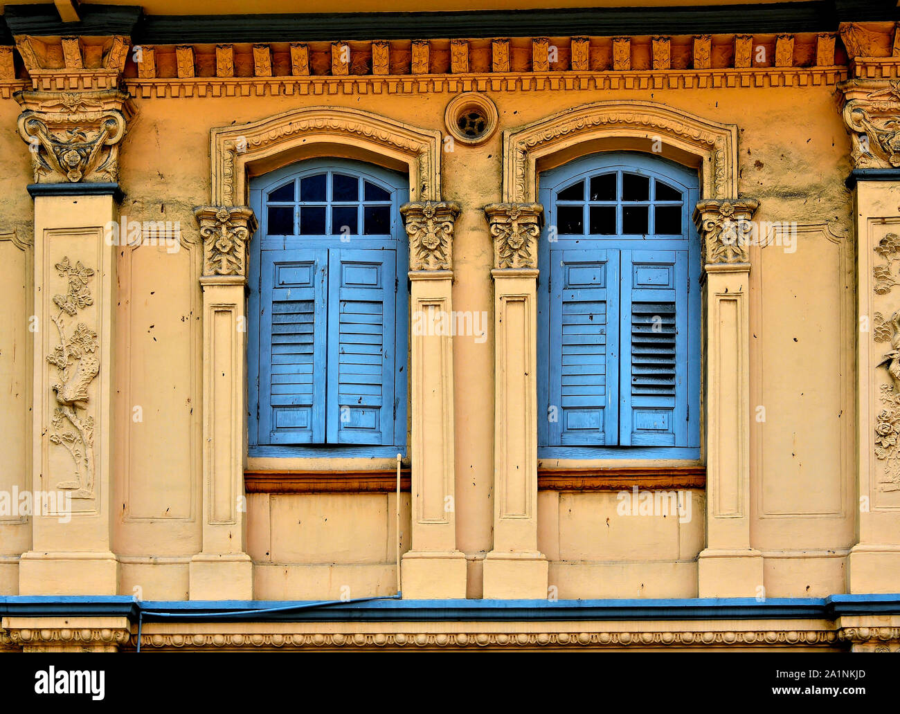 Front view of colourful Singapore shop house with antique blue wooden ...