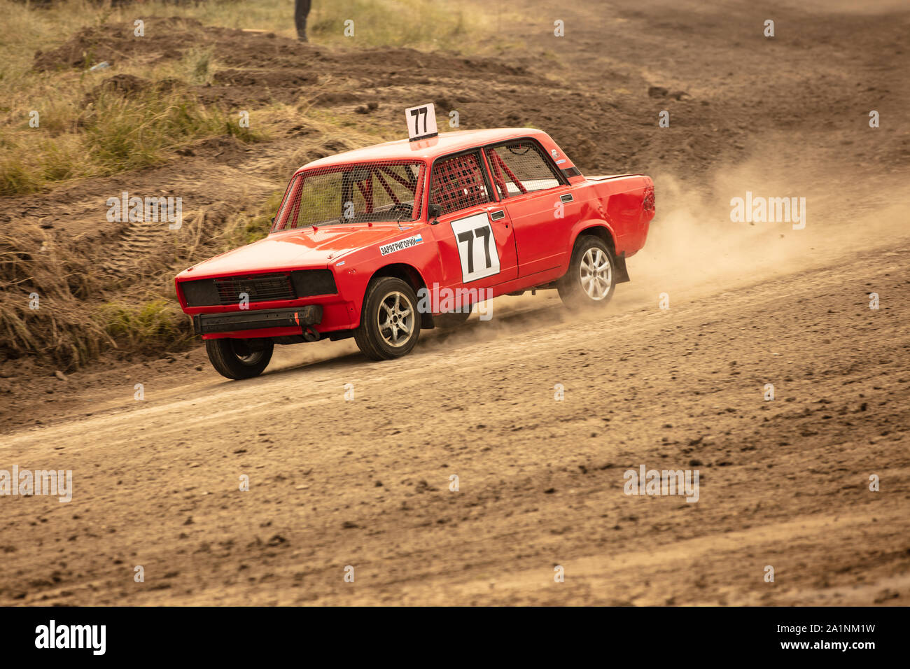 Traditional rally .The racing car drives into a steep turn, scattering ...