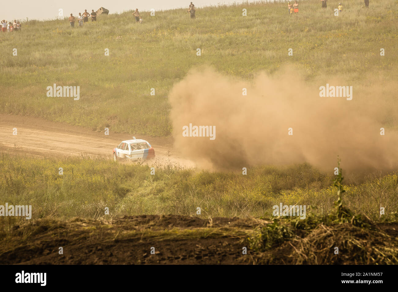 Traditional rally .The racing car drives into a steep turn, scattering ...