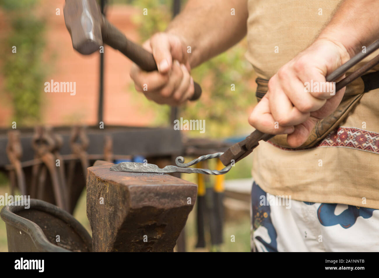 Blacksmith working on metal on an anvil Stock Photo - Alamy
