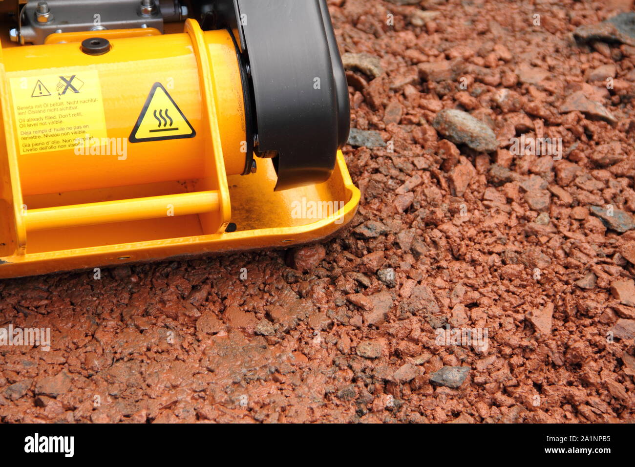 Road construction with a vibrating plate Stock Photo - Alamy