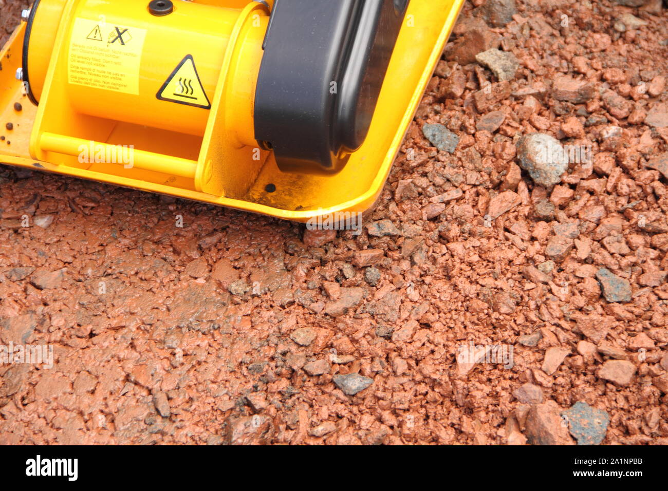 Road construction with a vibrating plate Stock Photo - Alamy