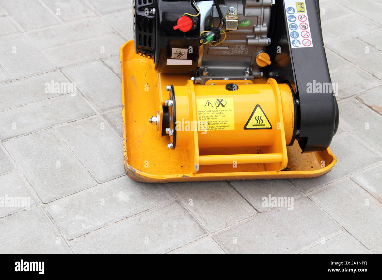 Road construction with a vibrating plate Stock Photo - Alamy