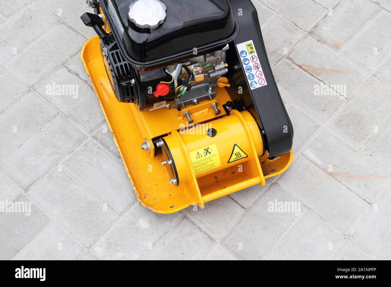 Road construction with a vibrating plate Stock Photo - Alamy