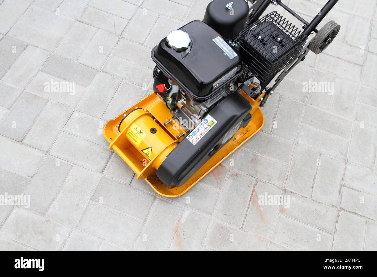 Road construction with a vibrating plate Stock Photo - Alamy