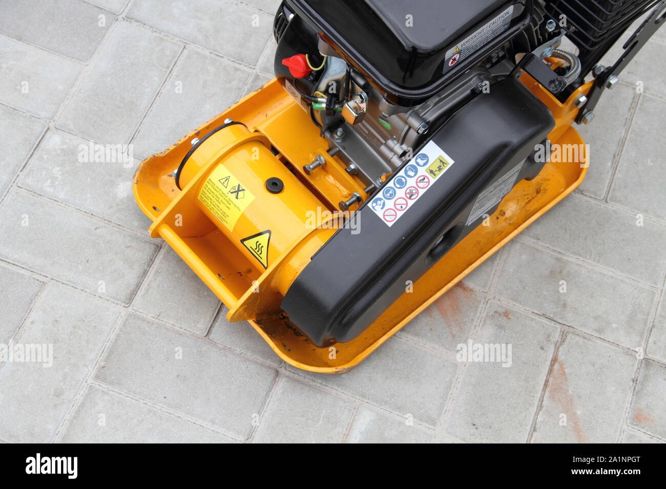 Road construction with a vibrating plate Stock Photo - Alamy