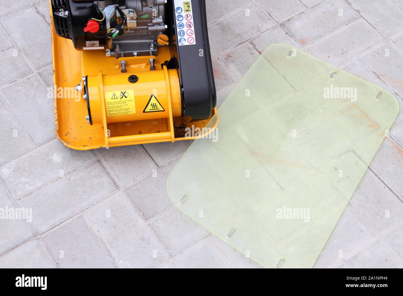 Road construction with a vibrating plate Stock Photo - Alamy