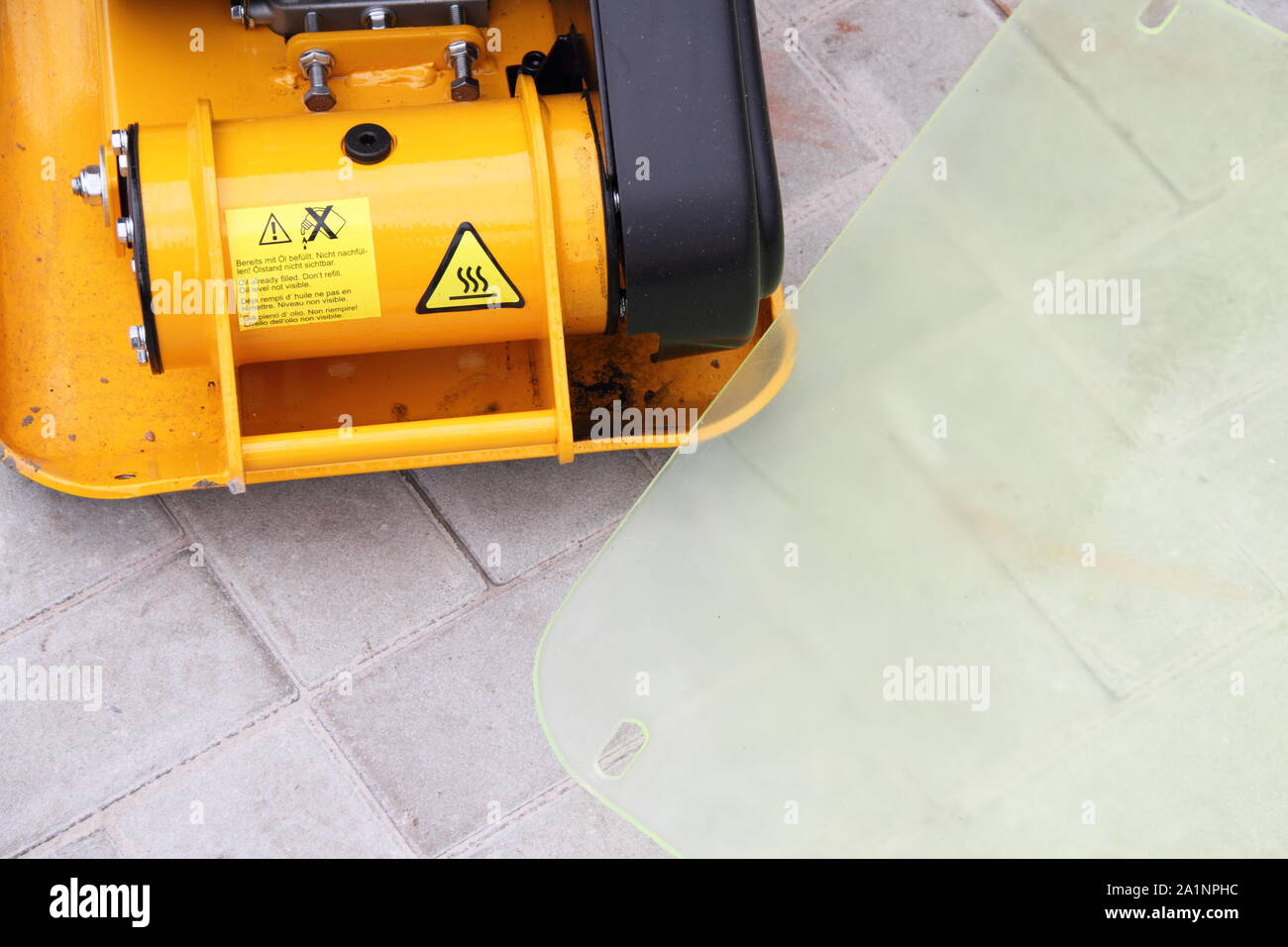 Road construction with a vibrating plate Stock Photo - Alamy