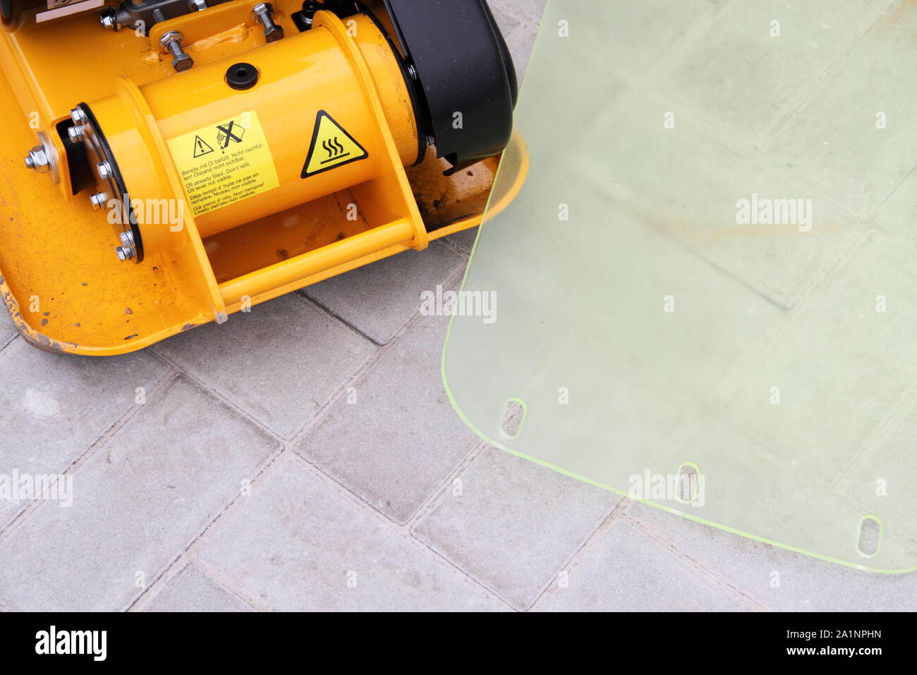 Road construction with a vibrating plate Stock Photo - Alamy