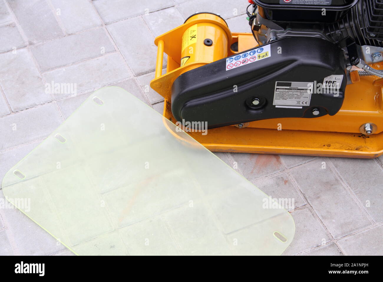 Road construction with a vibrating plate Stock Photo - Alamy