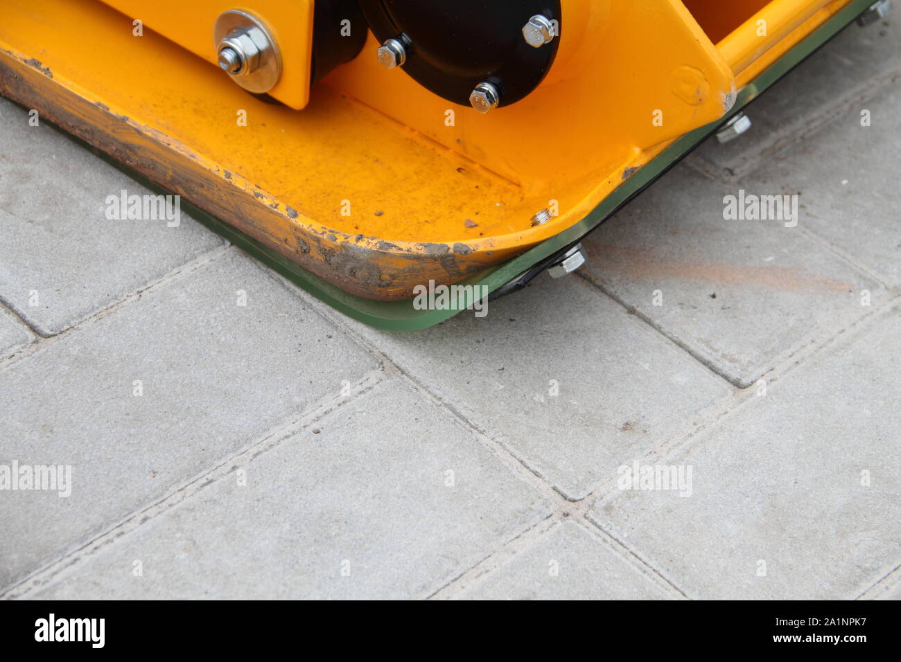 Road construction with a vibrating plate Stock Photo - Alamy