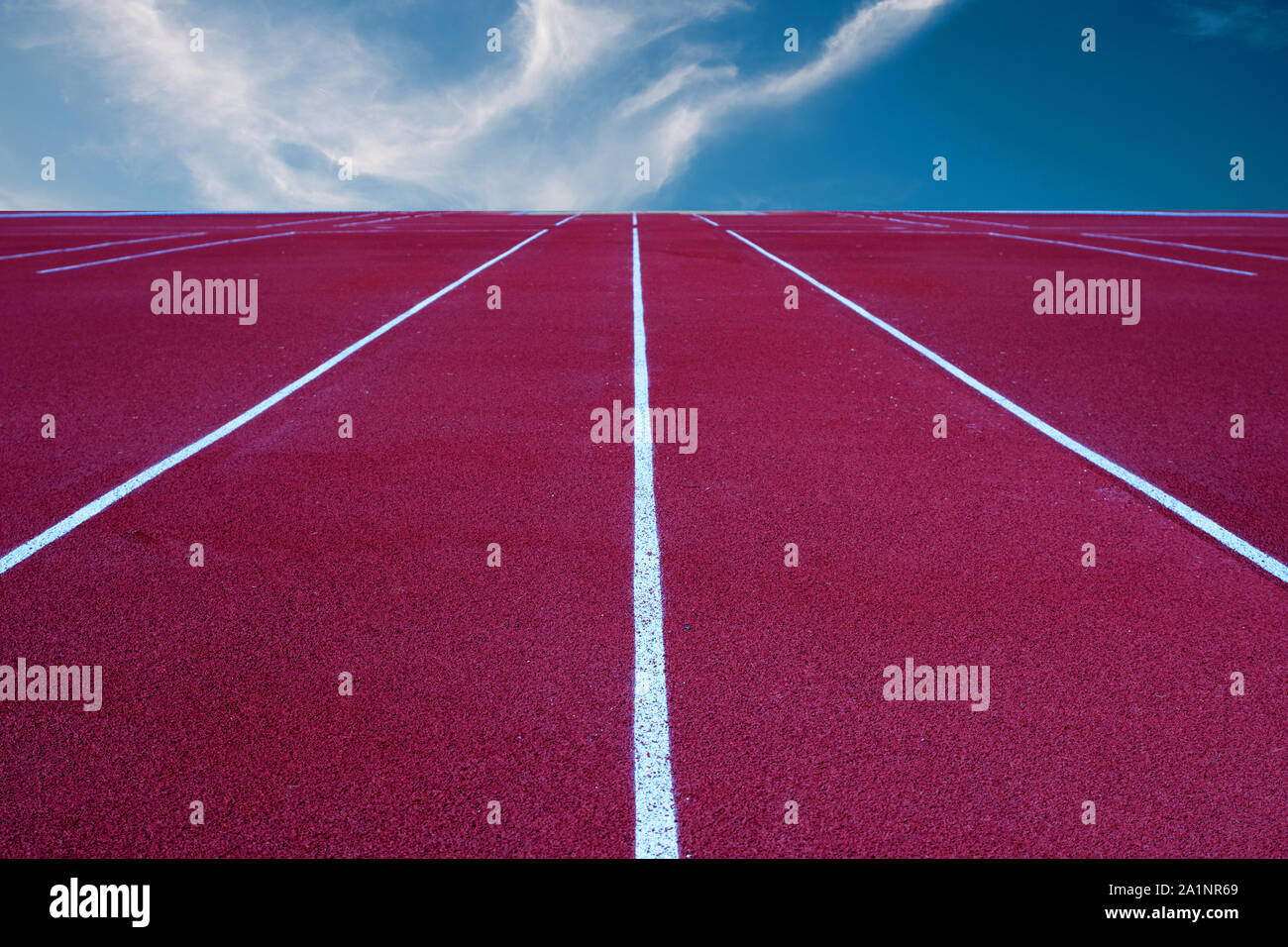 Running track with lanes over sky and clouds Stock Photo - Alamy