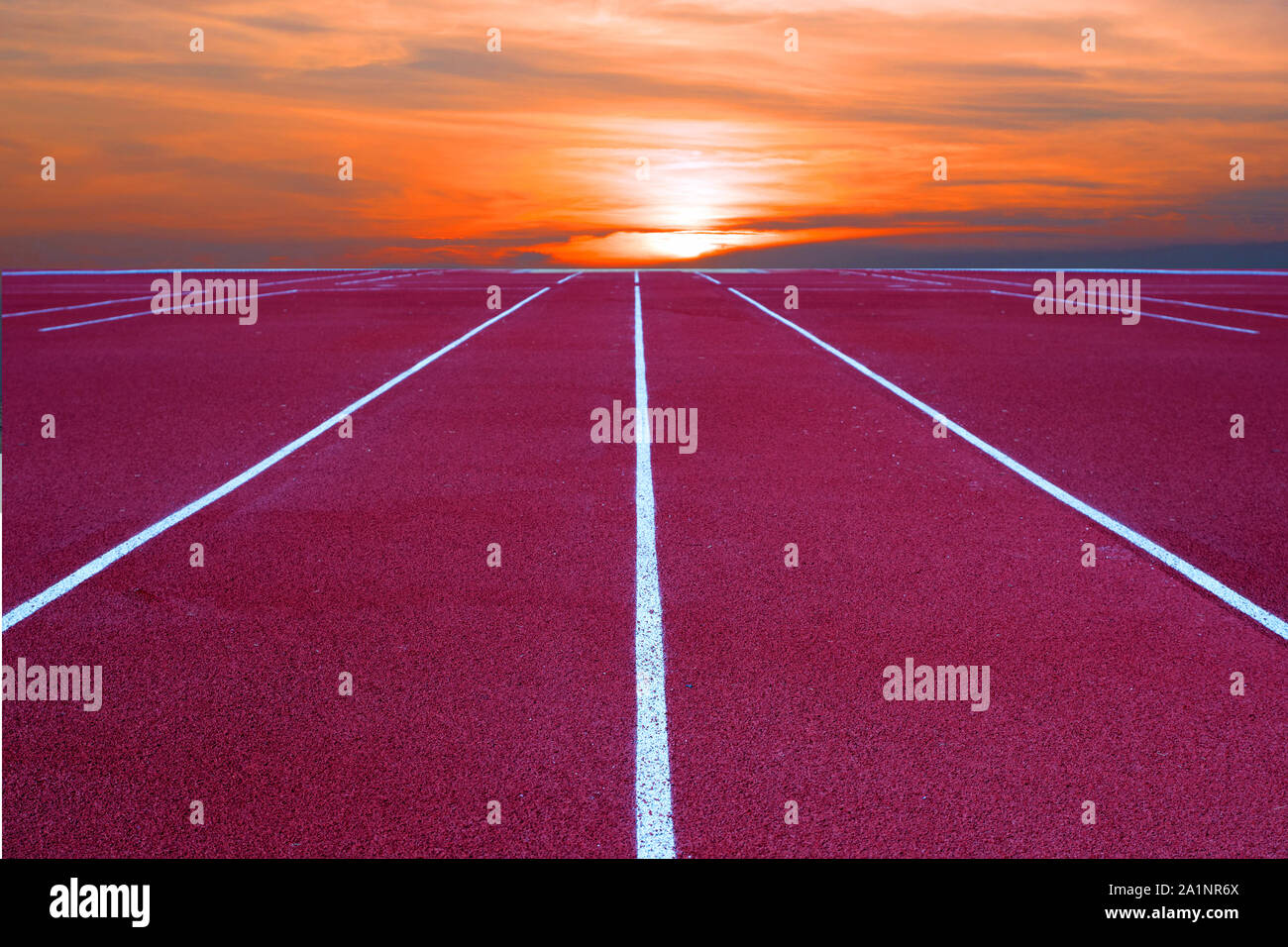 Running track with lanes over sky and clouds Stock Photo - Alamy