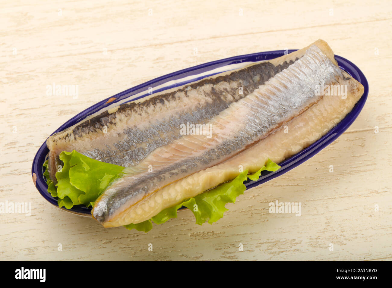 Herring fillet over salad leaves - ready for eat Stock Photo - Alamy