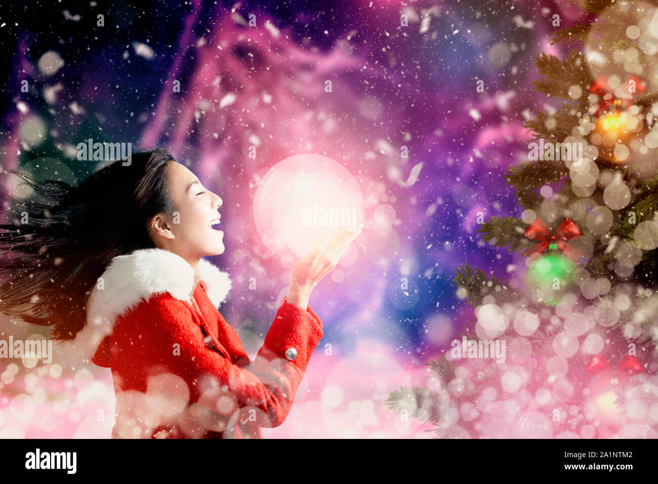 happy young woman watching the light ball and christmas background ...