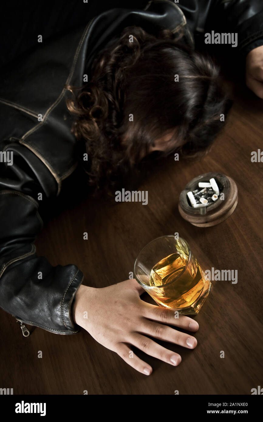 Wasted on the bar after a night of drinking Stock Photo - Alamy