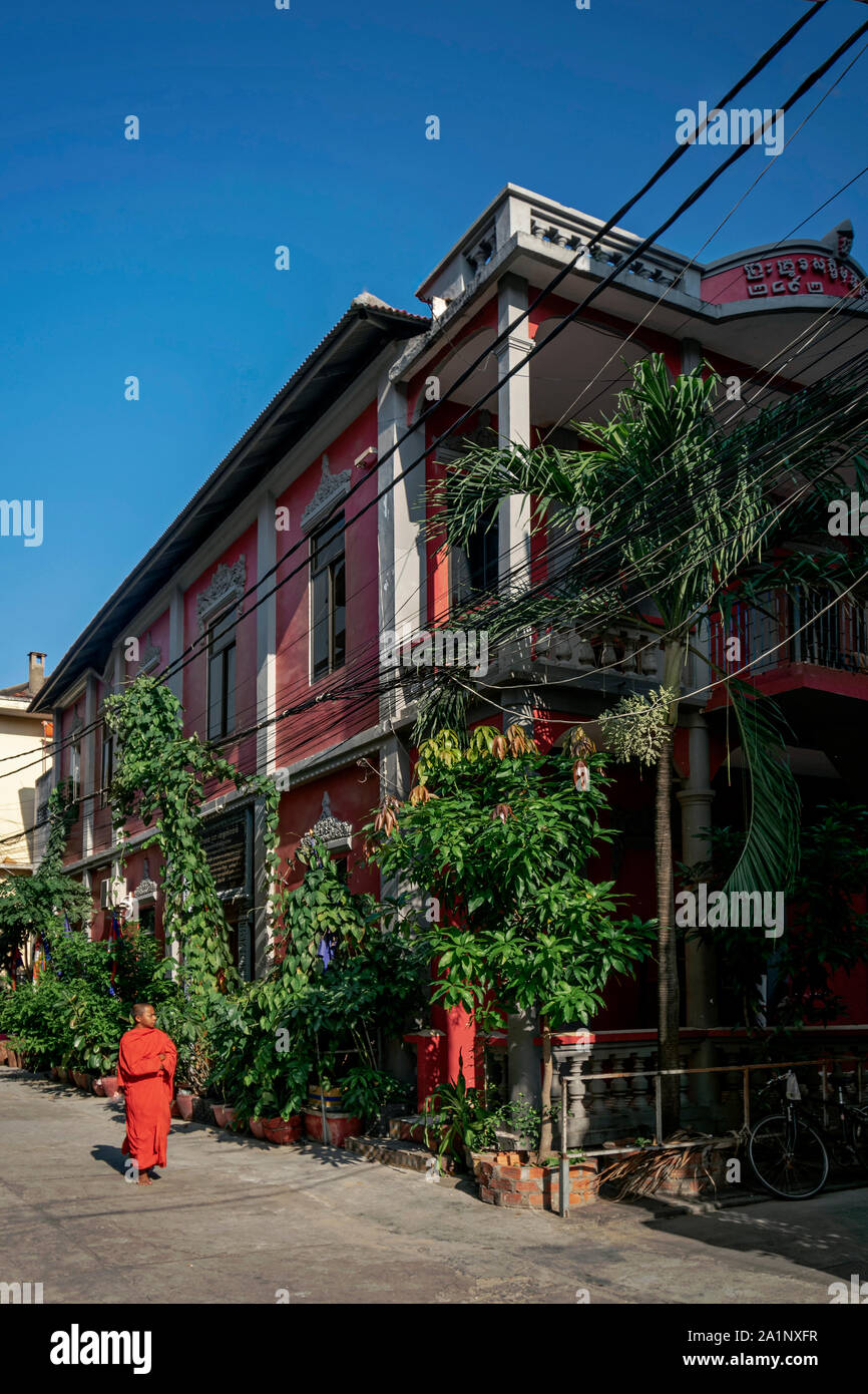 young buddhist monk walking in sunny phnom penh cambodia street inside ...