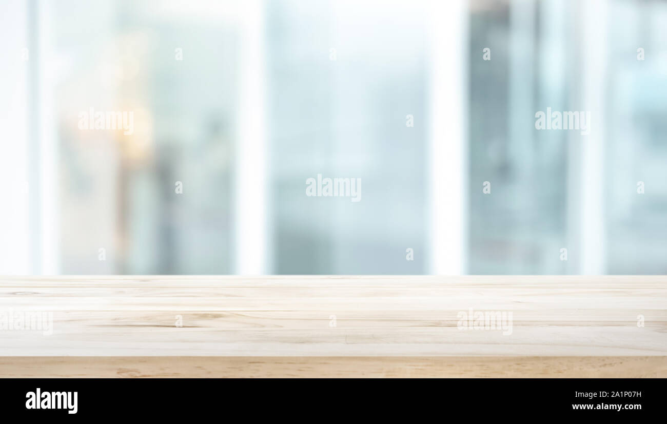 Selective focus of wood table top on white wall glass background.For ...