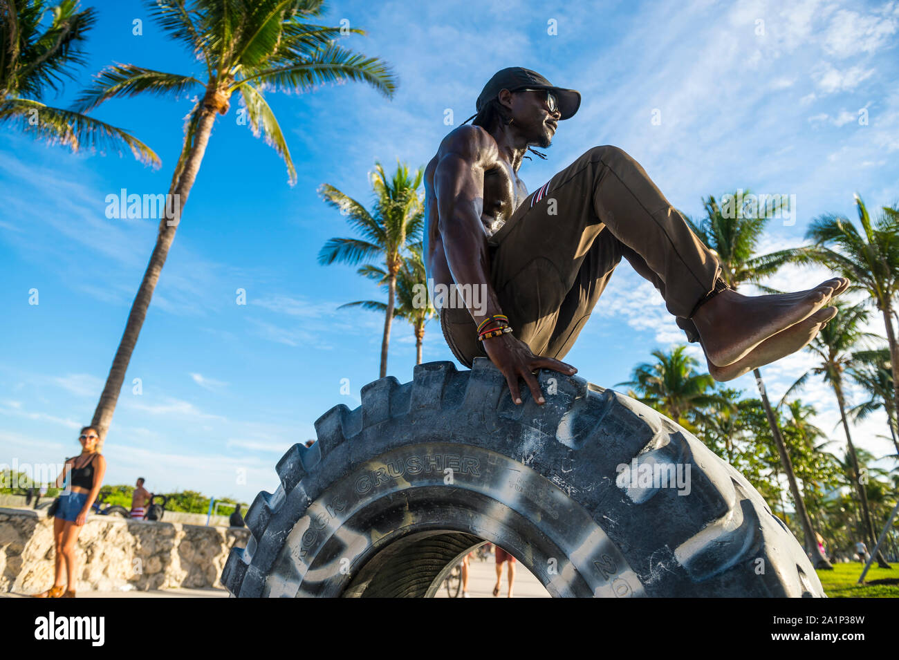 MIAMI - DECEMBER 27, 2017: A muscular young man works out at the ...