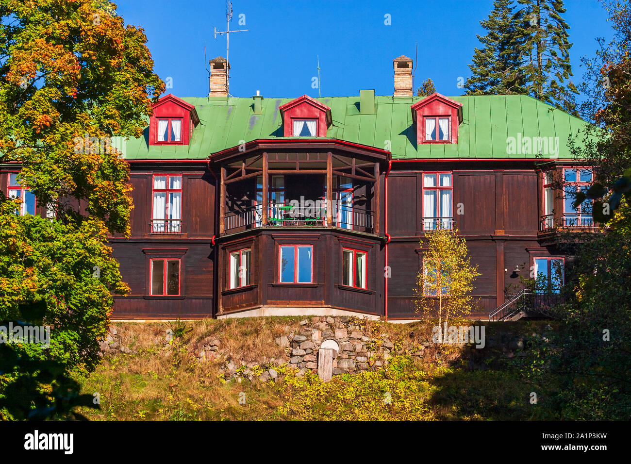 Wooden manor house with a balcony Stock Photo - Alamy
