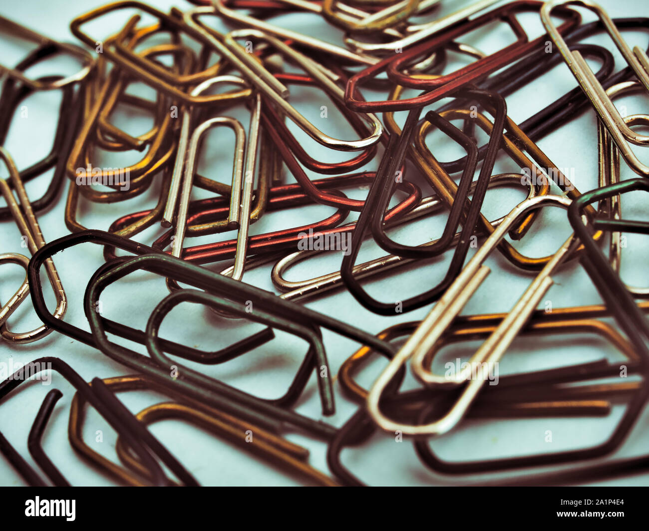 Colorful paperclips on light blue background. Old photo effect Stock ...
