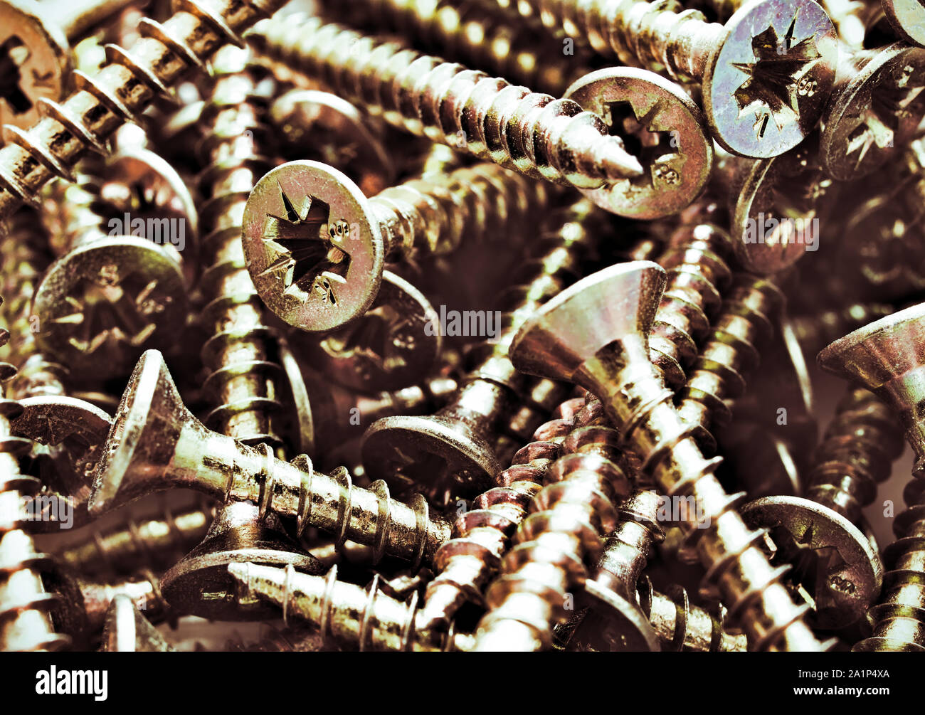 Stack of bronze wood steel screws. Close up macro, industrial seamless ...