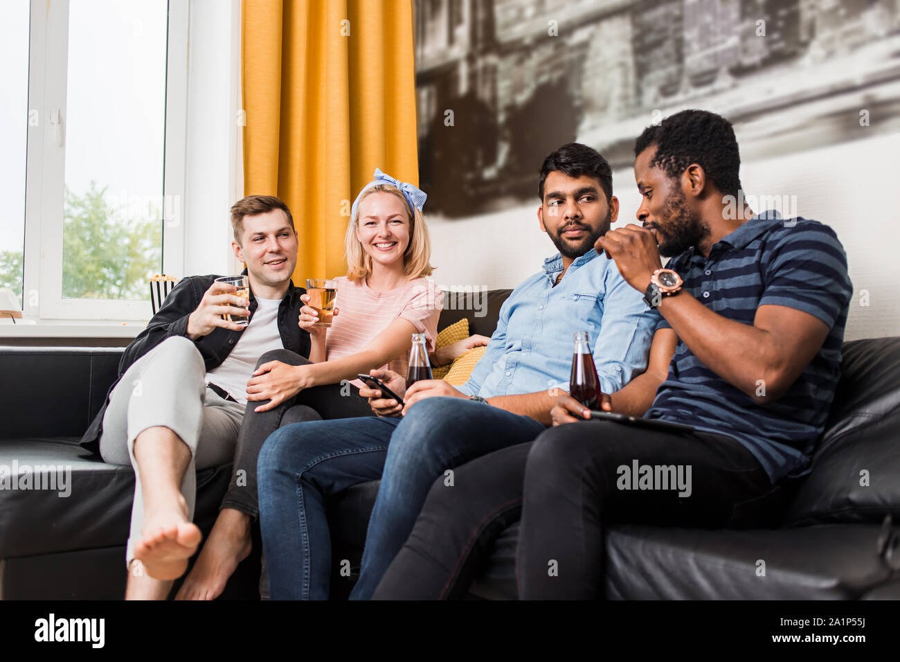 Friendship, entertainment concept. Shot of four happy friends sitting ...