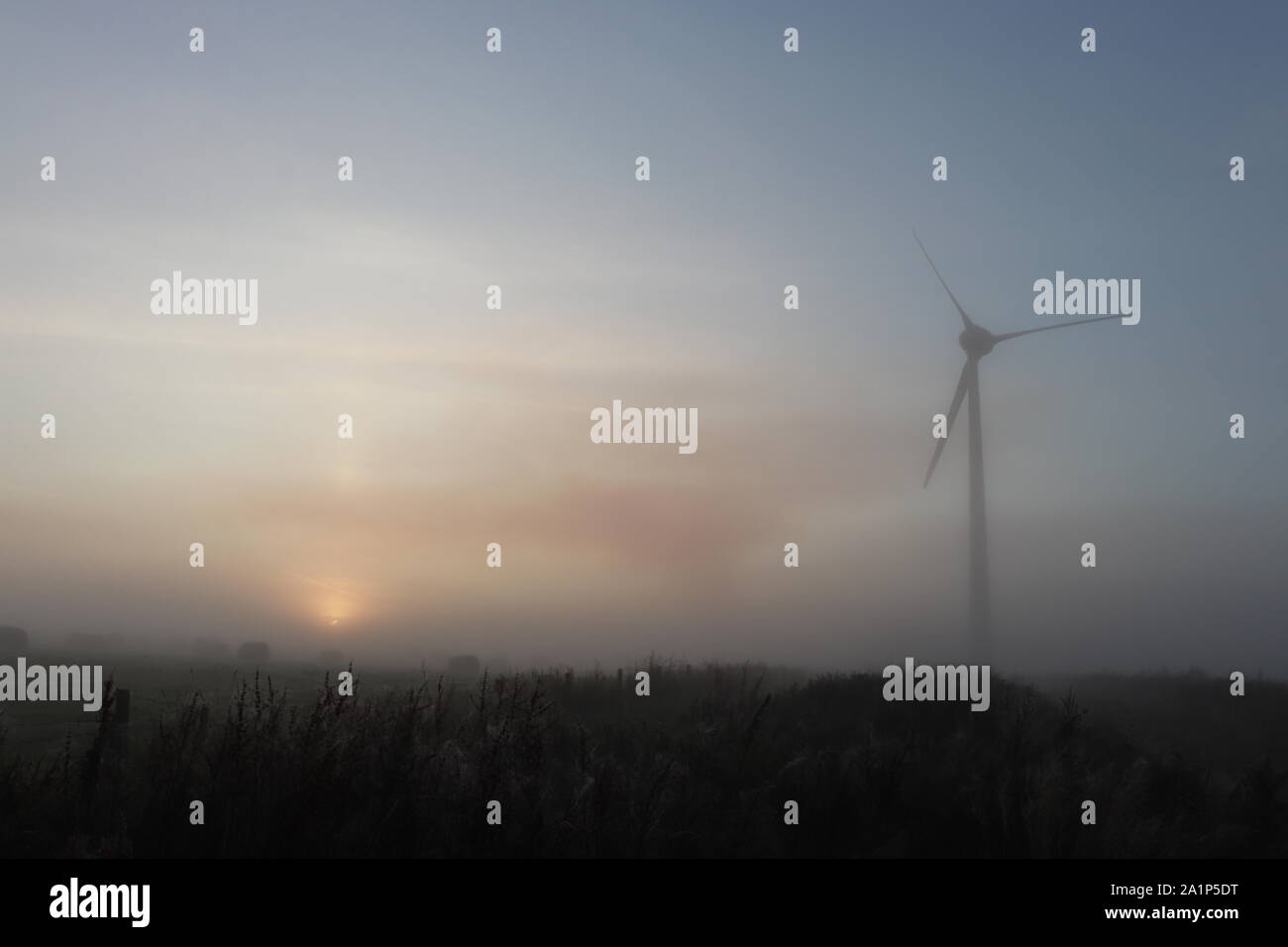 Wind turbine in mist Stock Photo - Alamy