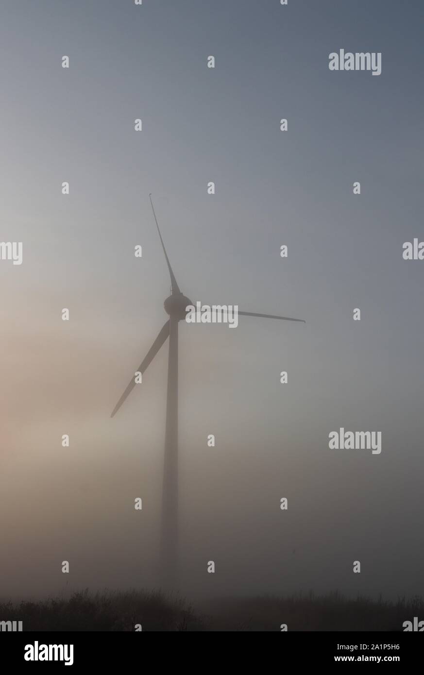 Wind turbine in mist Stock Photo - Alamy
