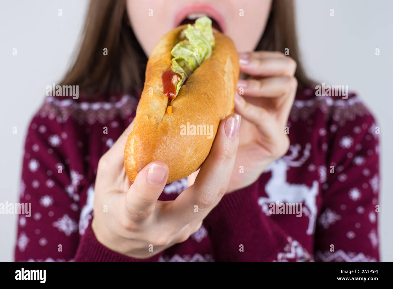 Over eating concept. Cropped closeup photo of crazy hungry girl trying ...