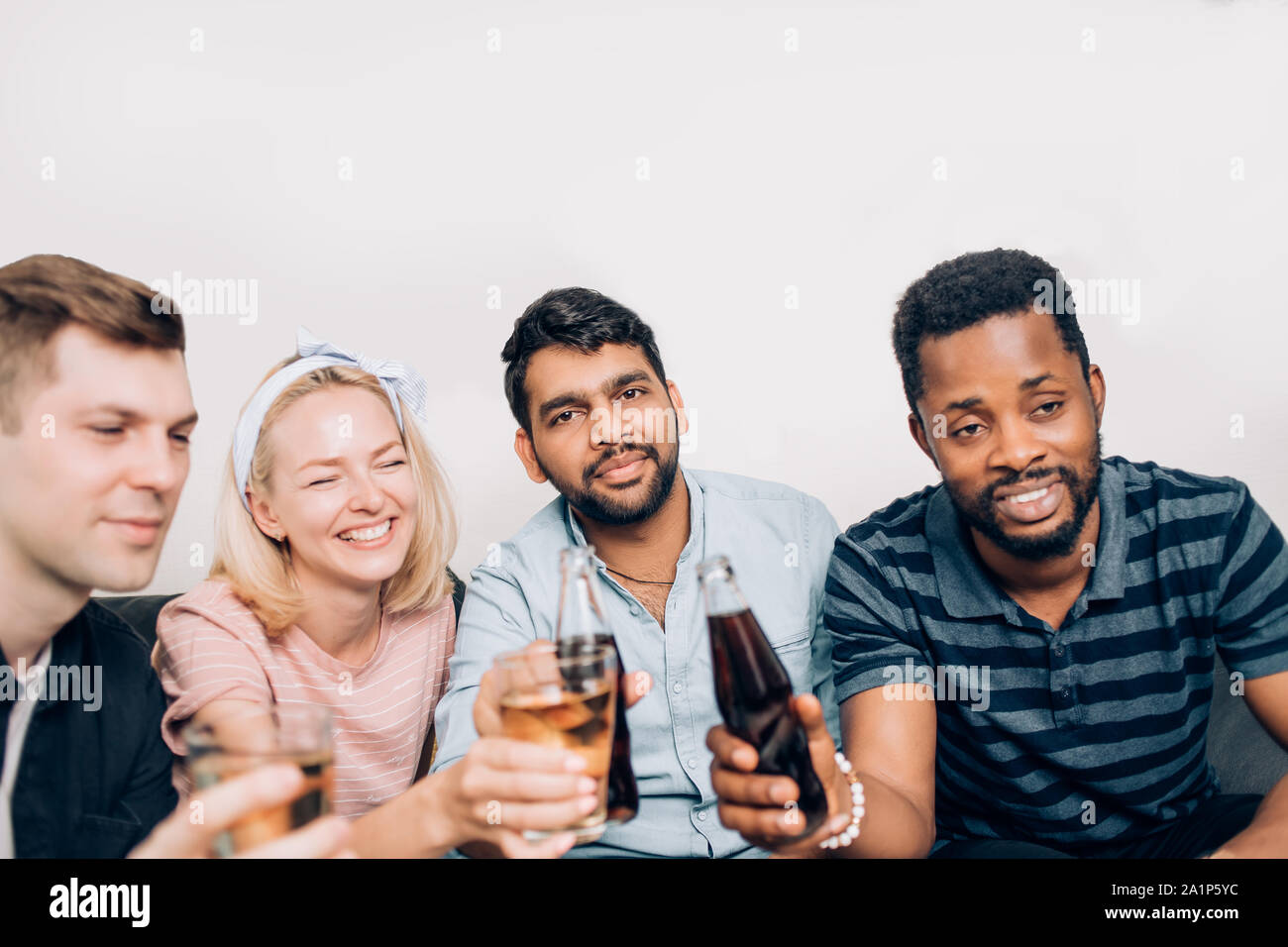 Four friends having small home party, celebrating meeting, sitting on ...